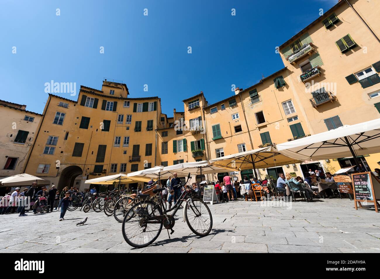 Tourists and locals visit the ancient Town square (Piazza dell ...