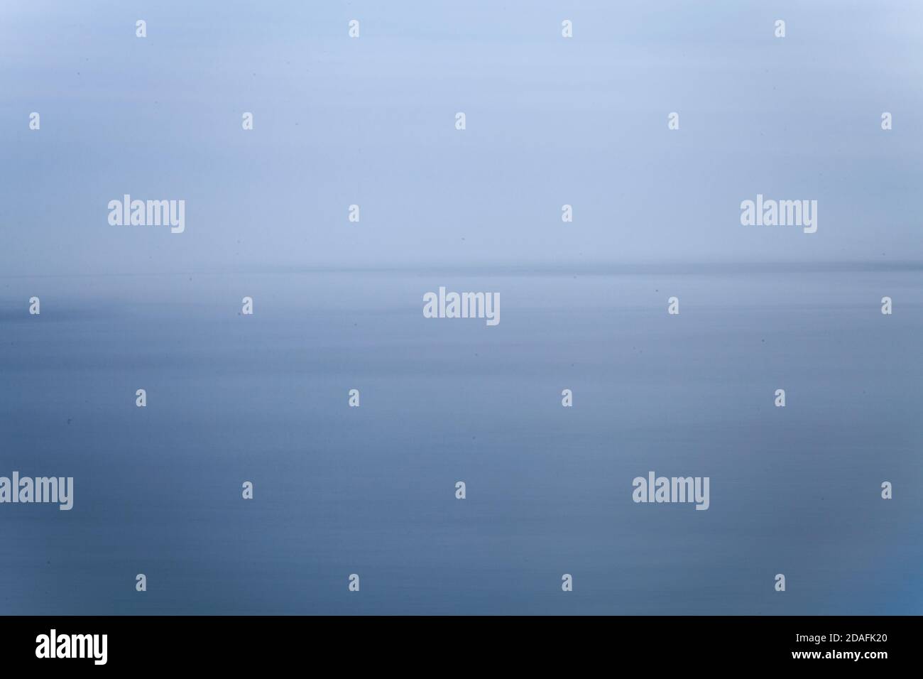 Where the sky meets the sea, blue hazy abstract image Stock Photo - Alamy