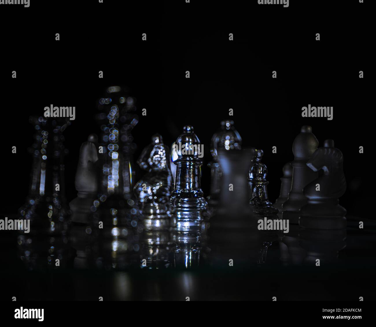 Shot of transparent chess pieces on a black background Stock Photo - Alamy