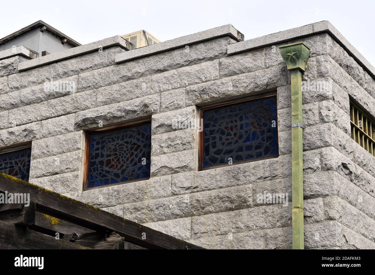 Side of a building with facade siding and patterned windows Stock Photo ...
