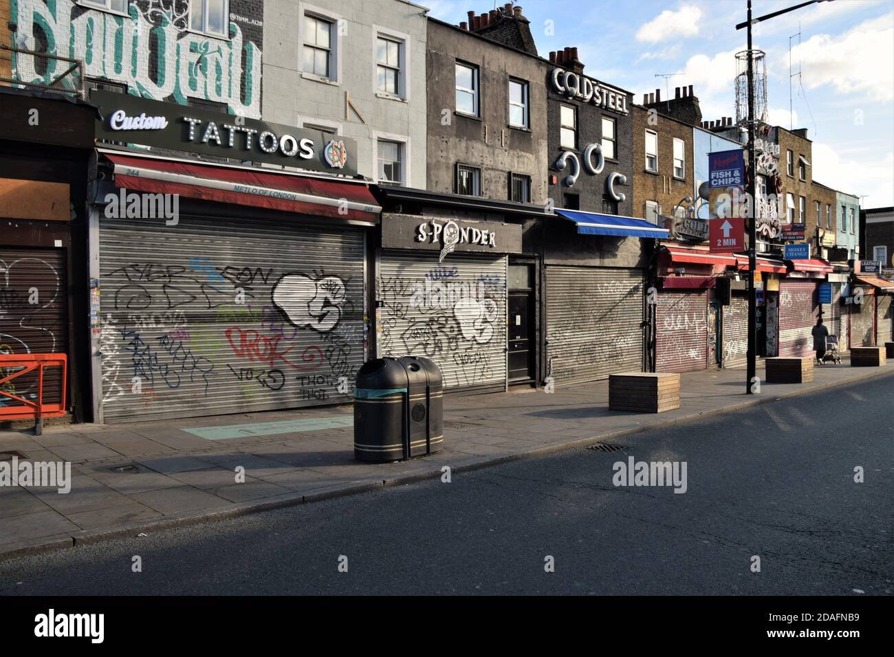 Daytime view of an empty and deserted Camden High Street. Most shops ...
