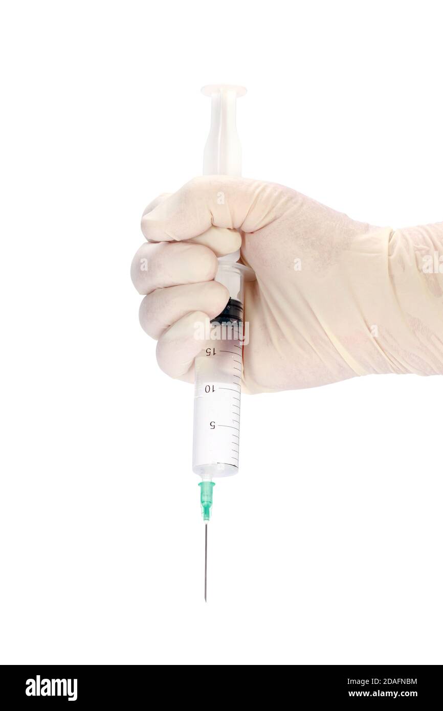 Closeup of a doctor with gloves on holding a needle downwards on a ...