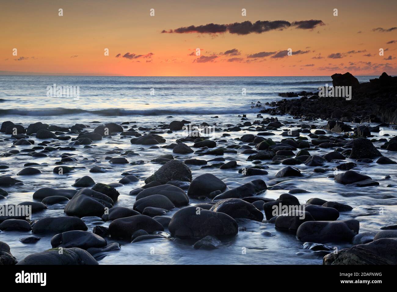 Sunset on the beach at Duckpool in Cornwall Stock Photo - Alamy