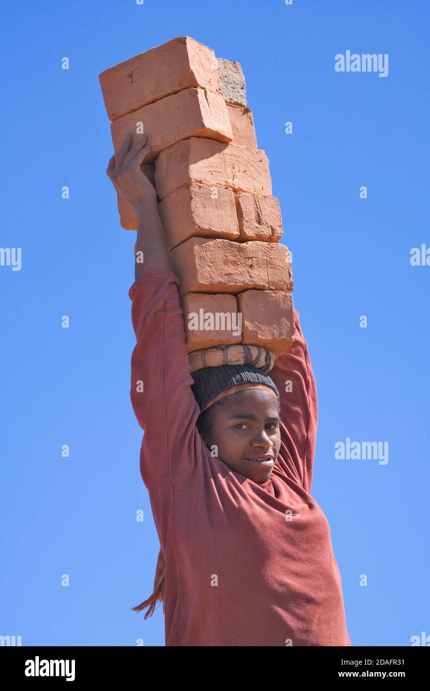 Man carrying bricks hi-res stock photography and images - Alamy