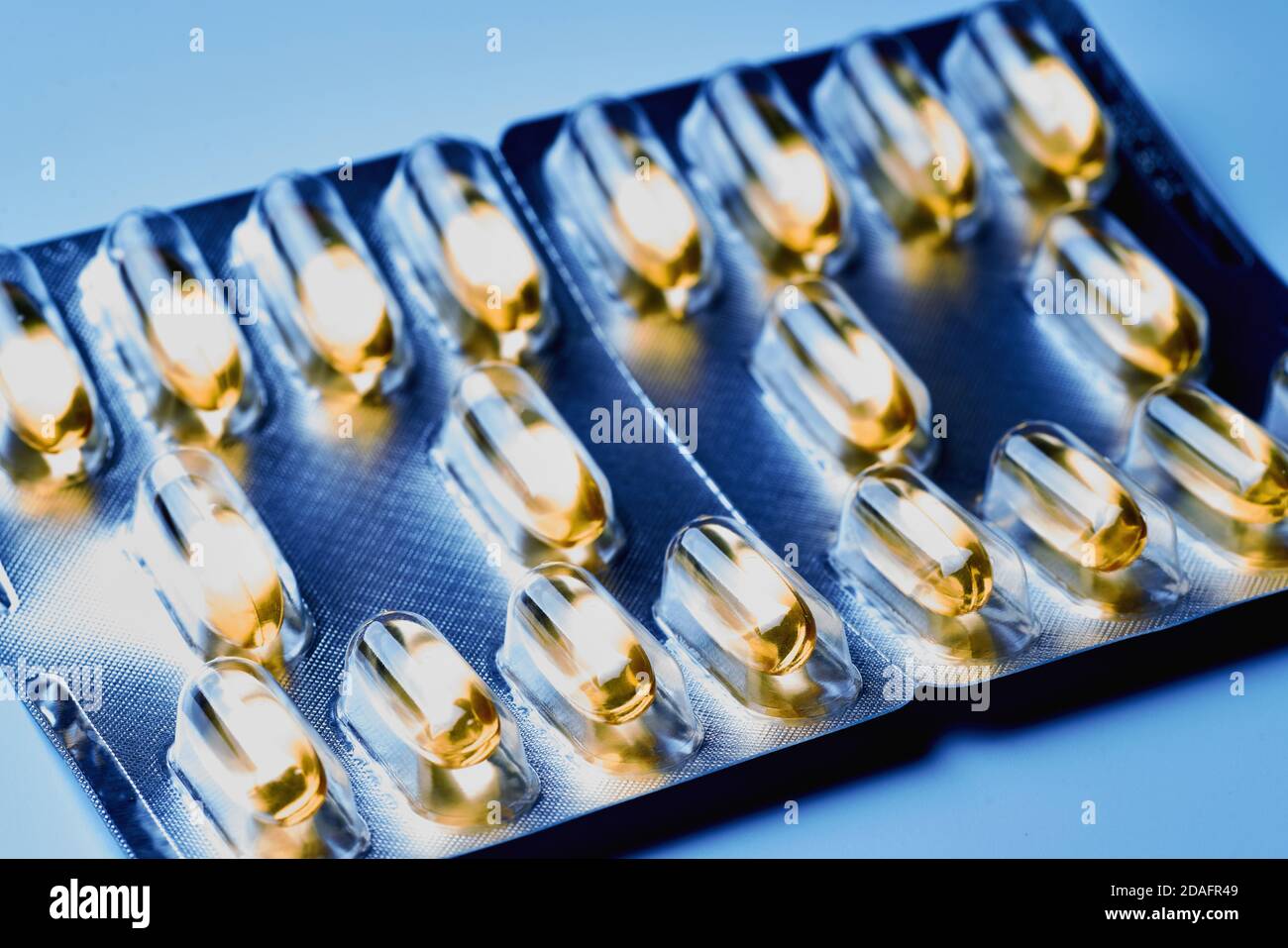 Metal blister with yellow medicinal capsules close-up Stock Photo - Alamy