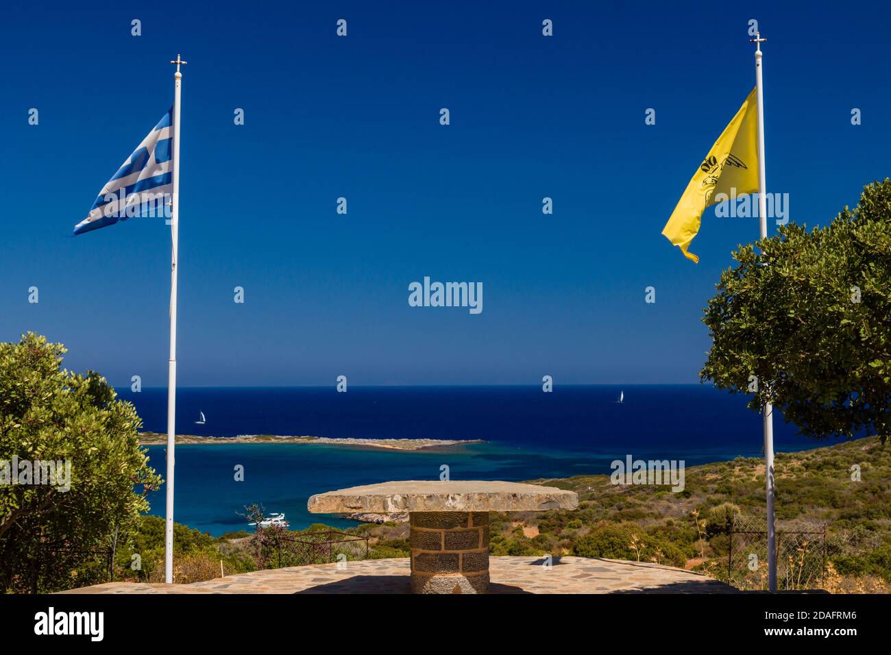 An outside altar with Greek and Byzantine flags at a small church ...