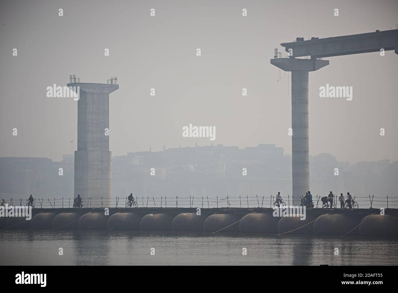 Varanasi, India, December 2015. People crossing a temporary bridge on ...