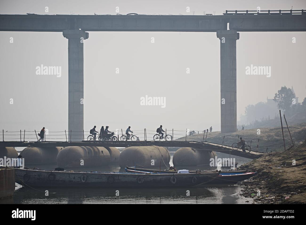 Varanasi, India, December 2015. People crossing a temporary bridge on ...