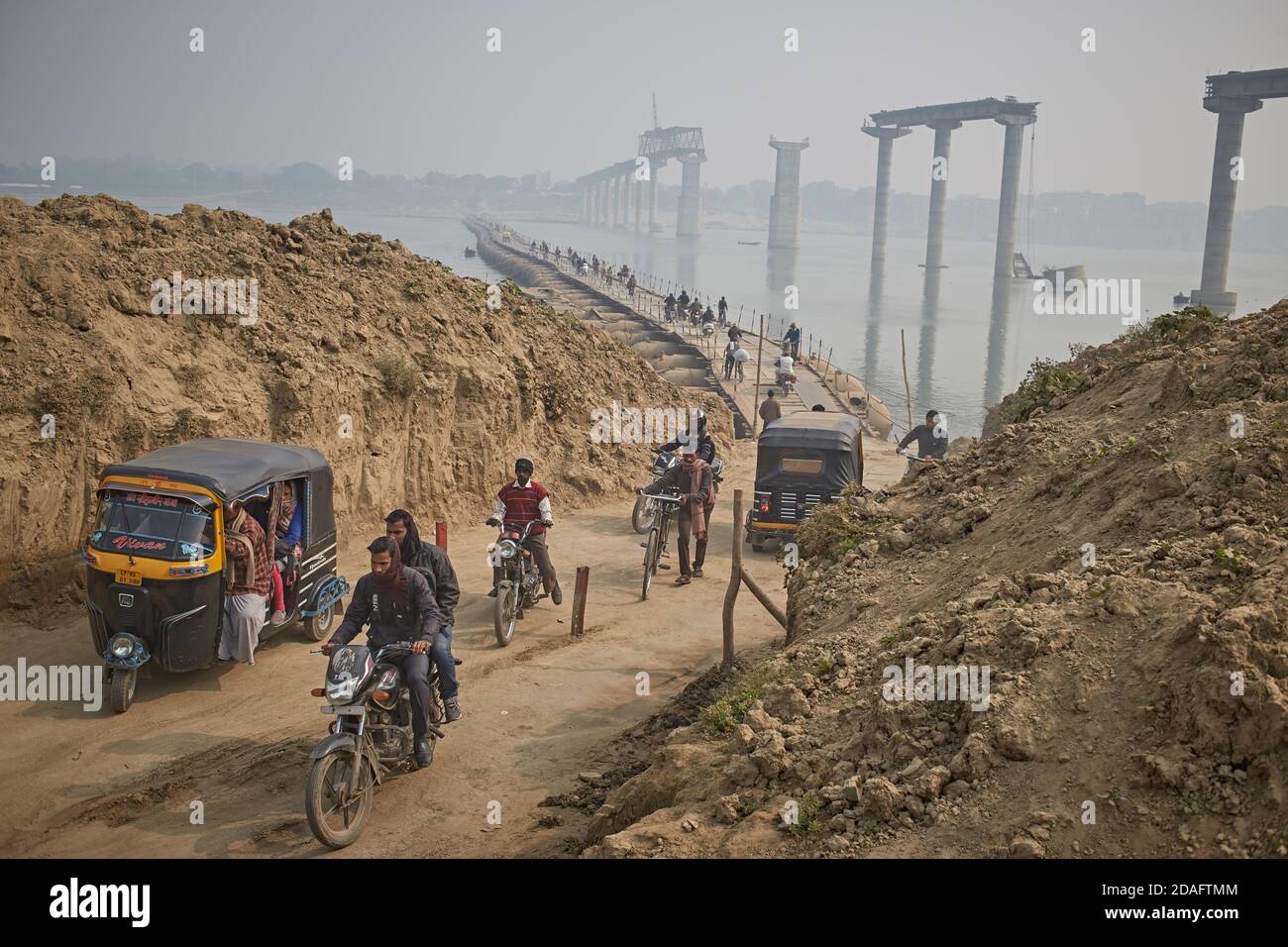 Varanasi, India, December 2015. People crossing a temporary bridge on ...