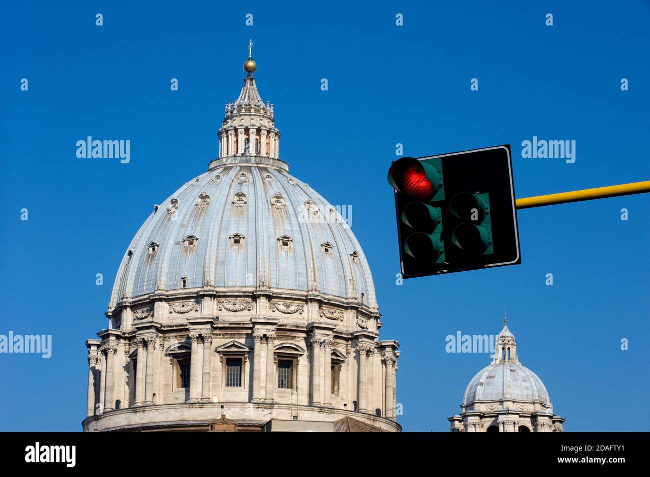 strange view of the dome of San Pietro in Rome with the red traffic ...