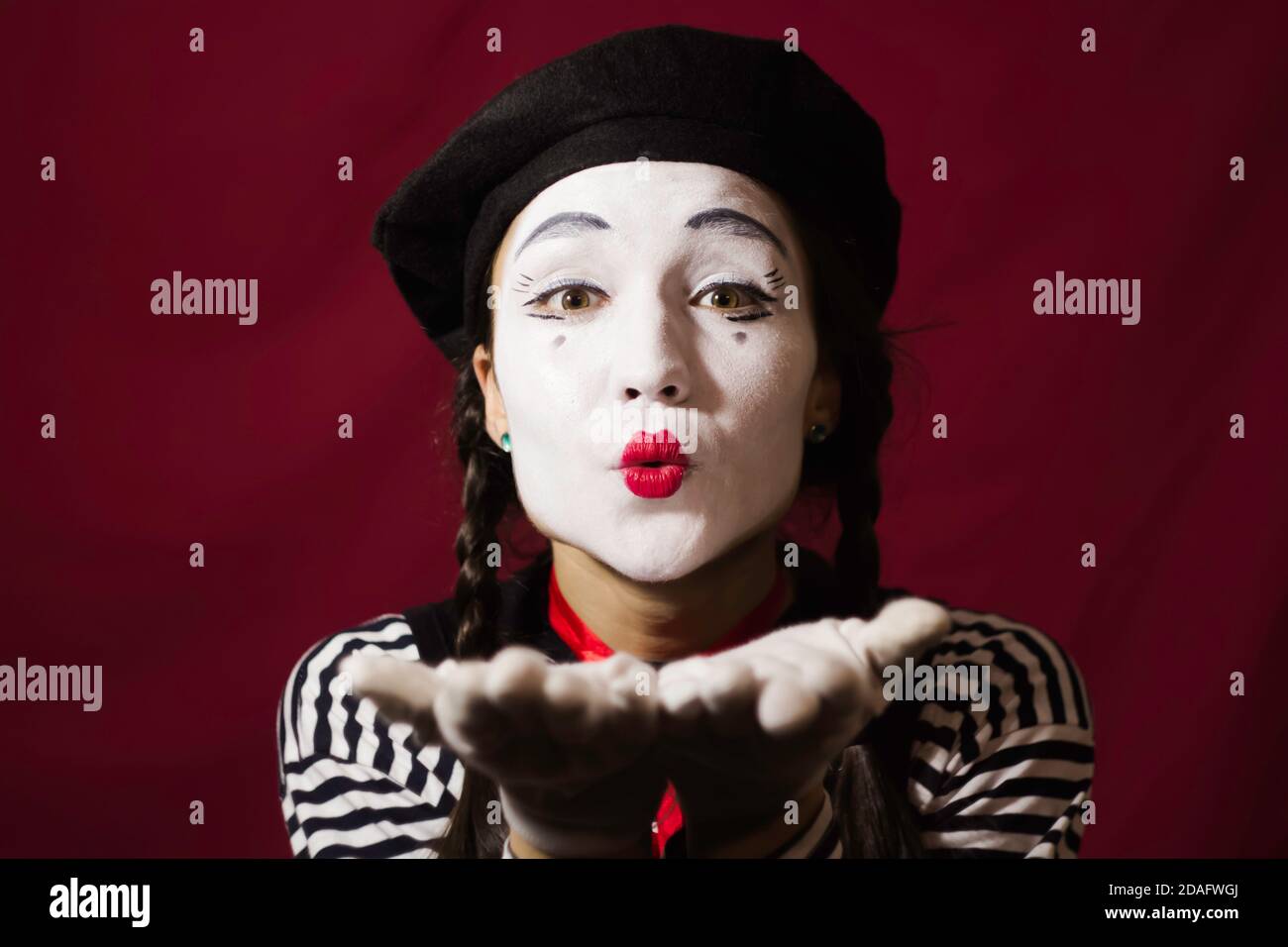 Beautiful girl mime sends air kiss .Beautiful mime girl smiling ...