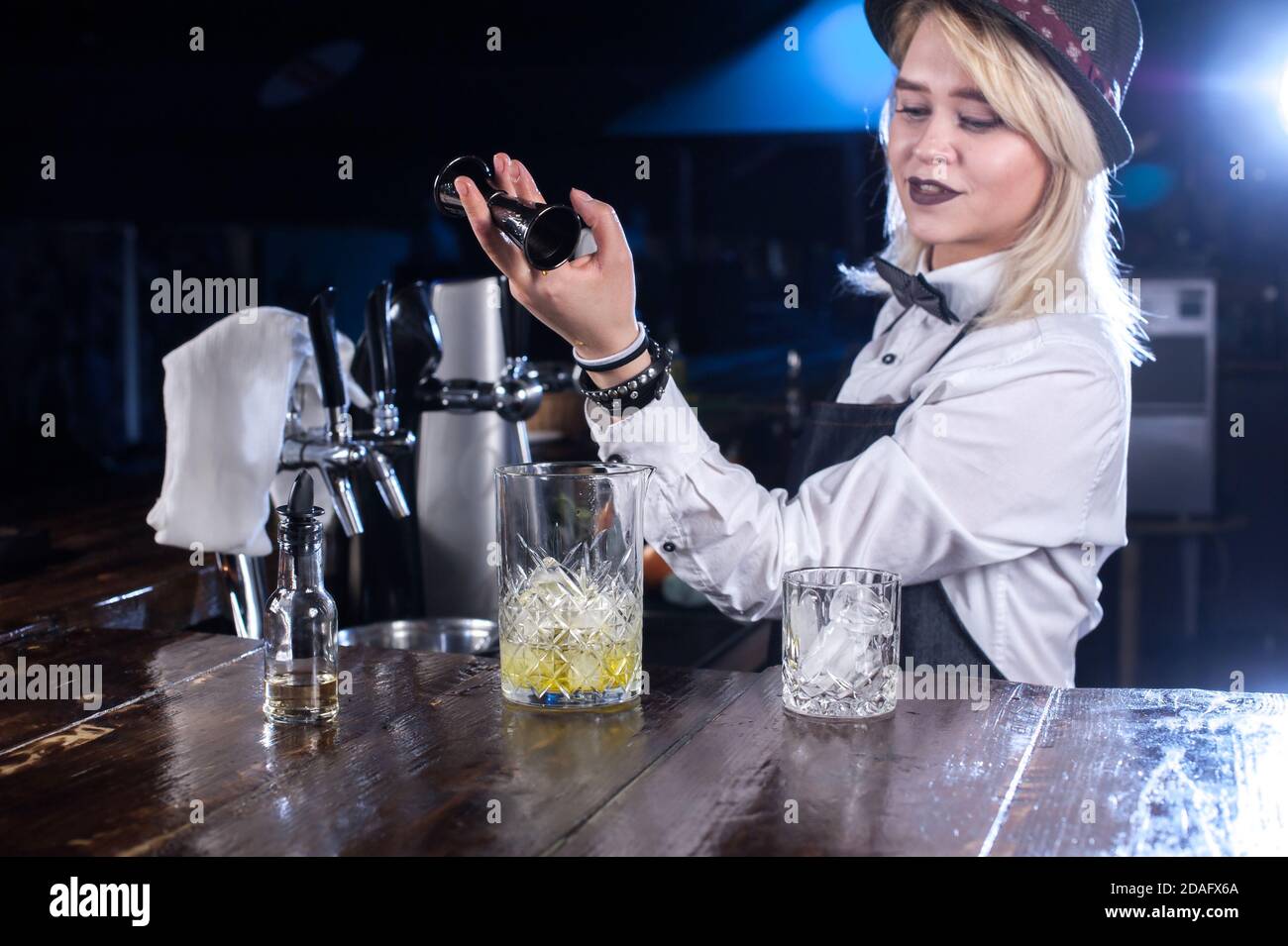 Charming woman mixologist mixes a cocktail at the bar counter Stock ...