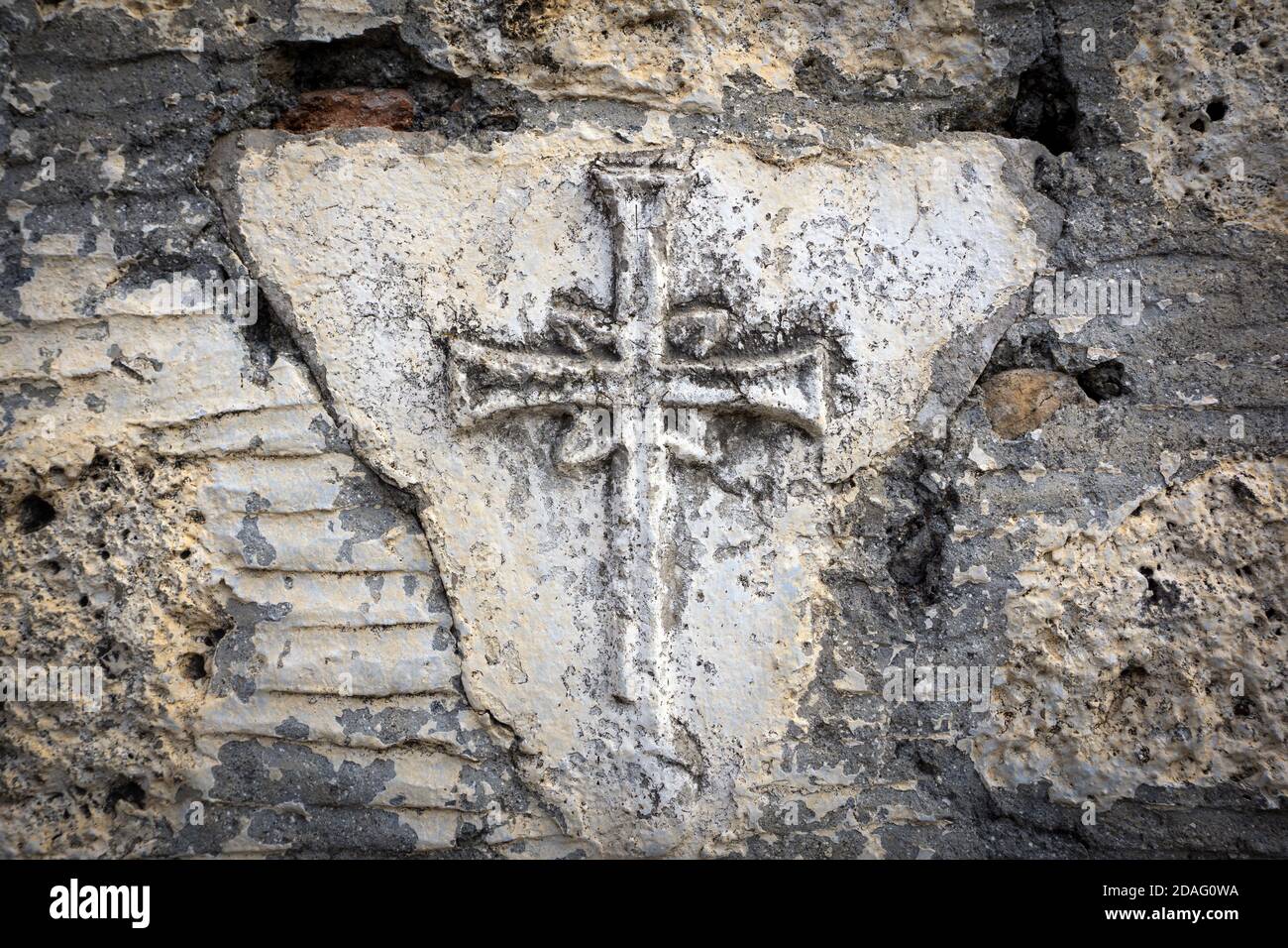 Ancient Greek Christian cross on the old stone wall of the temple Stock ...