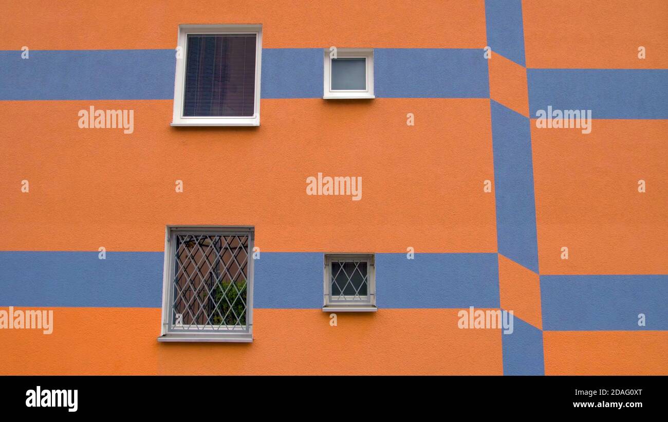 orange and blue colorful building facade with windows. modern german ...