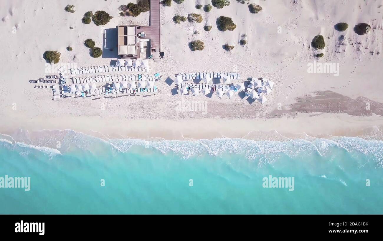 Aerial top view of bar on the beach and turquoise sea, with umbrellas ...