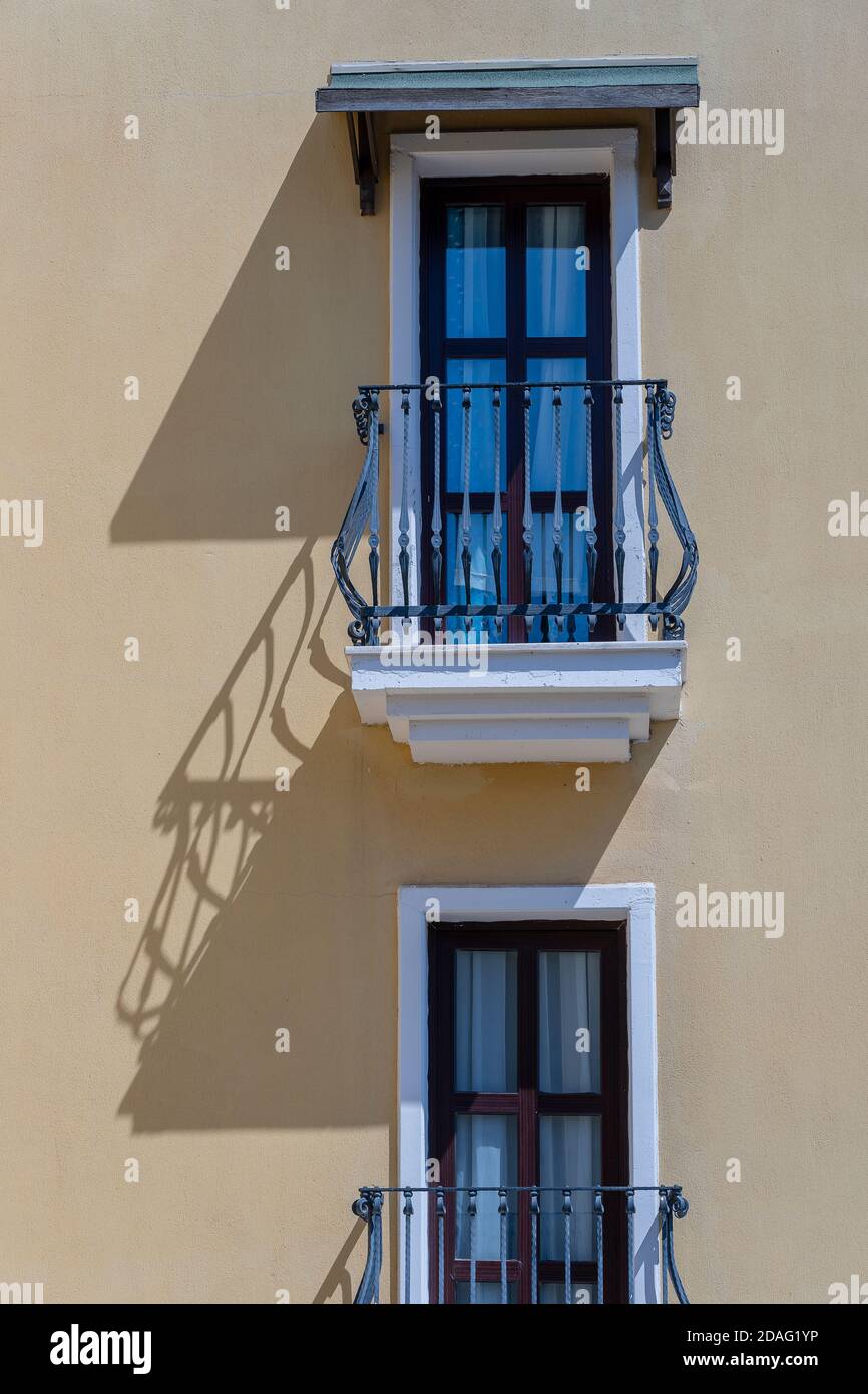 Windows with balcony on building facade with cast iron ornaments in ...
