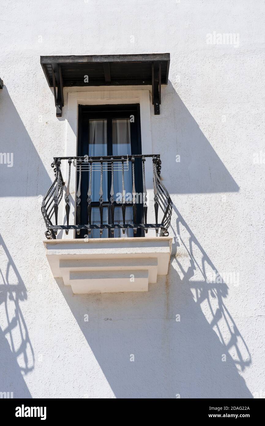 Windows with balcony on building facade with cast iron ornaments in ...
