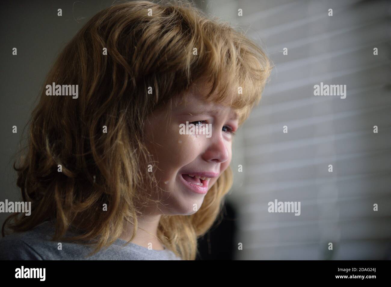 Close up of a kids face crying tears. Upset child. Violence in family ...