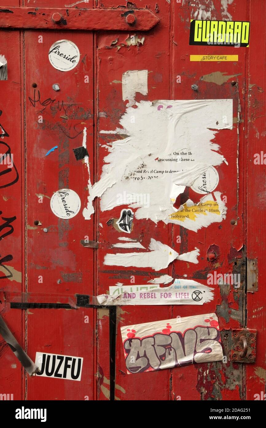 Stickers on red painted wooden door Stock Photo - Alamy