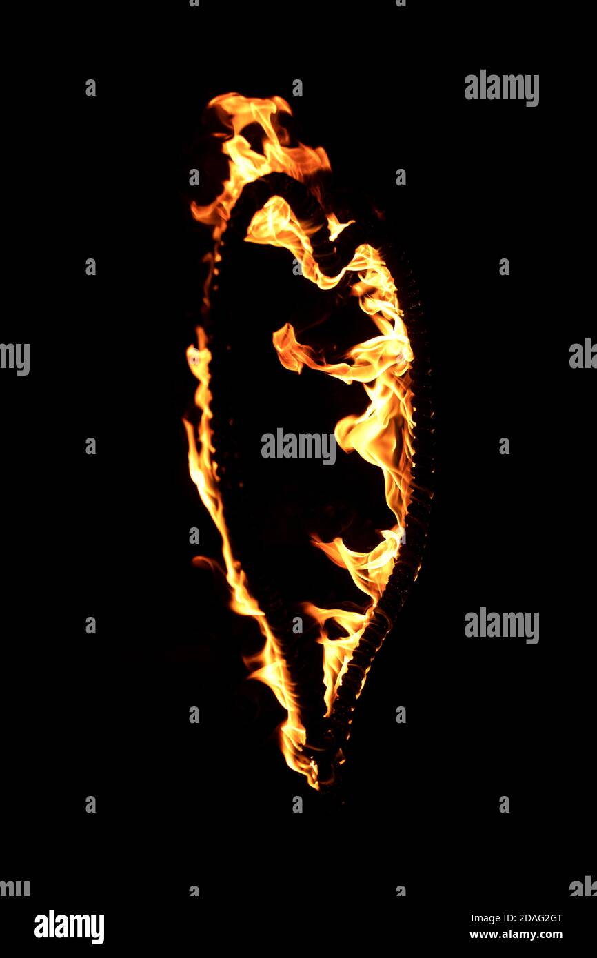 Burning heart with flames. Isolated on dark background. fire show in ...