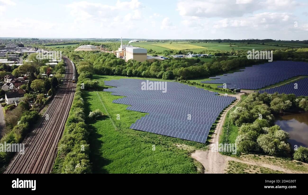 aerial view of Solar Panels in green field next to the rail train Stock ...