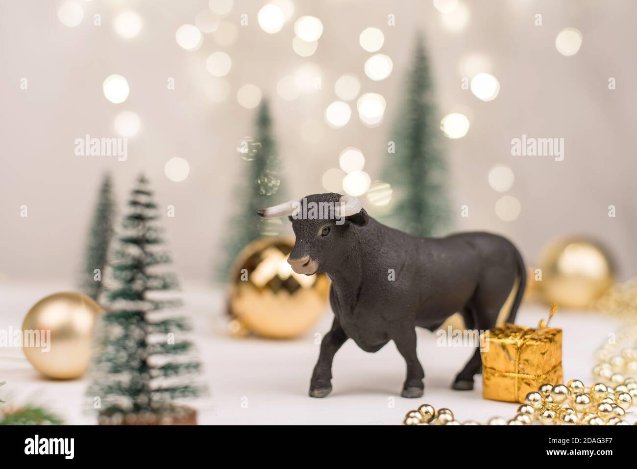 Decorative bull symbol of New Year on the background of Christmas tree ...