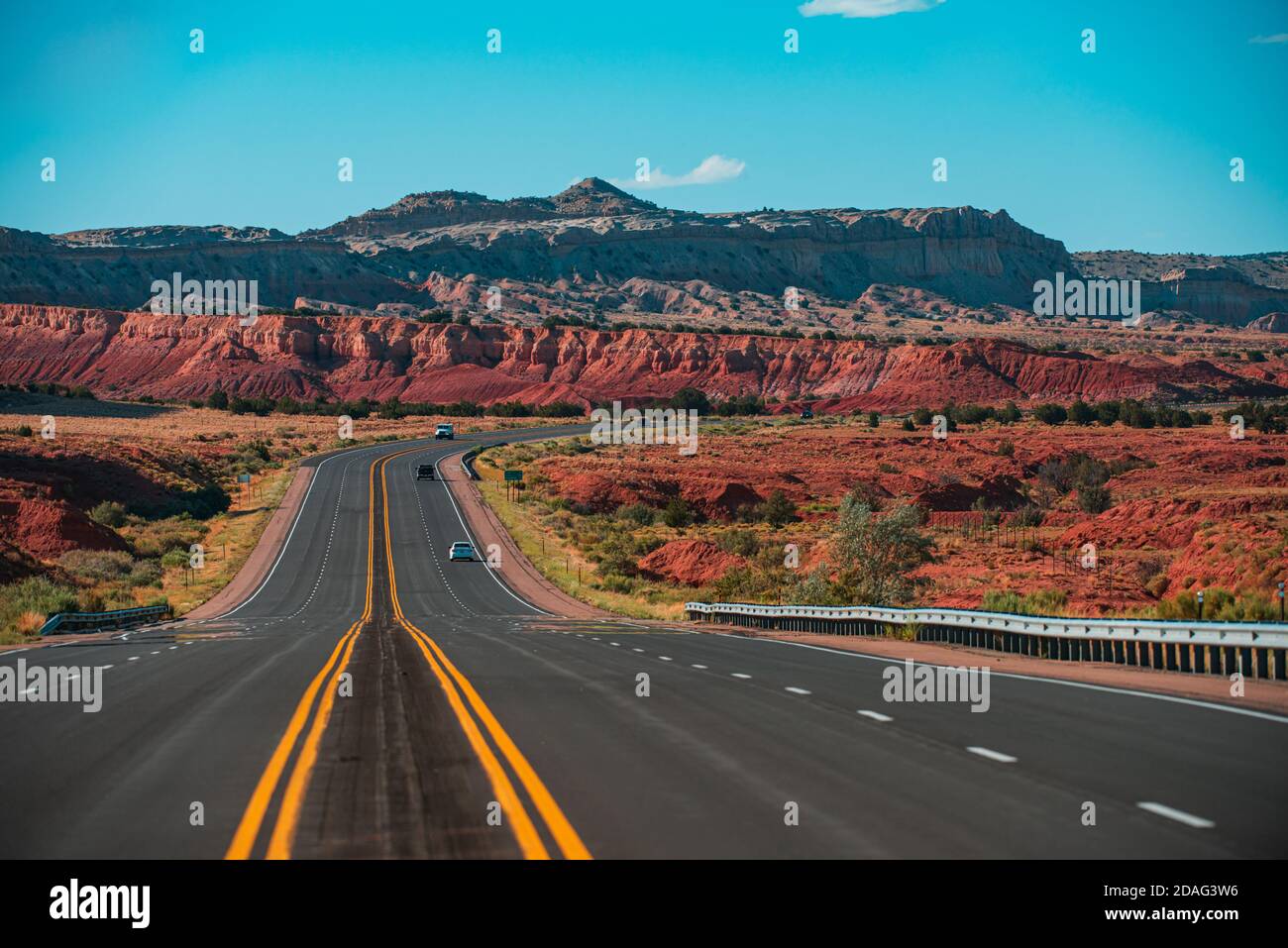 Landscape with rocks, sunny sky with clouds and beautiful asphalt road ...