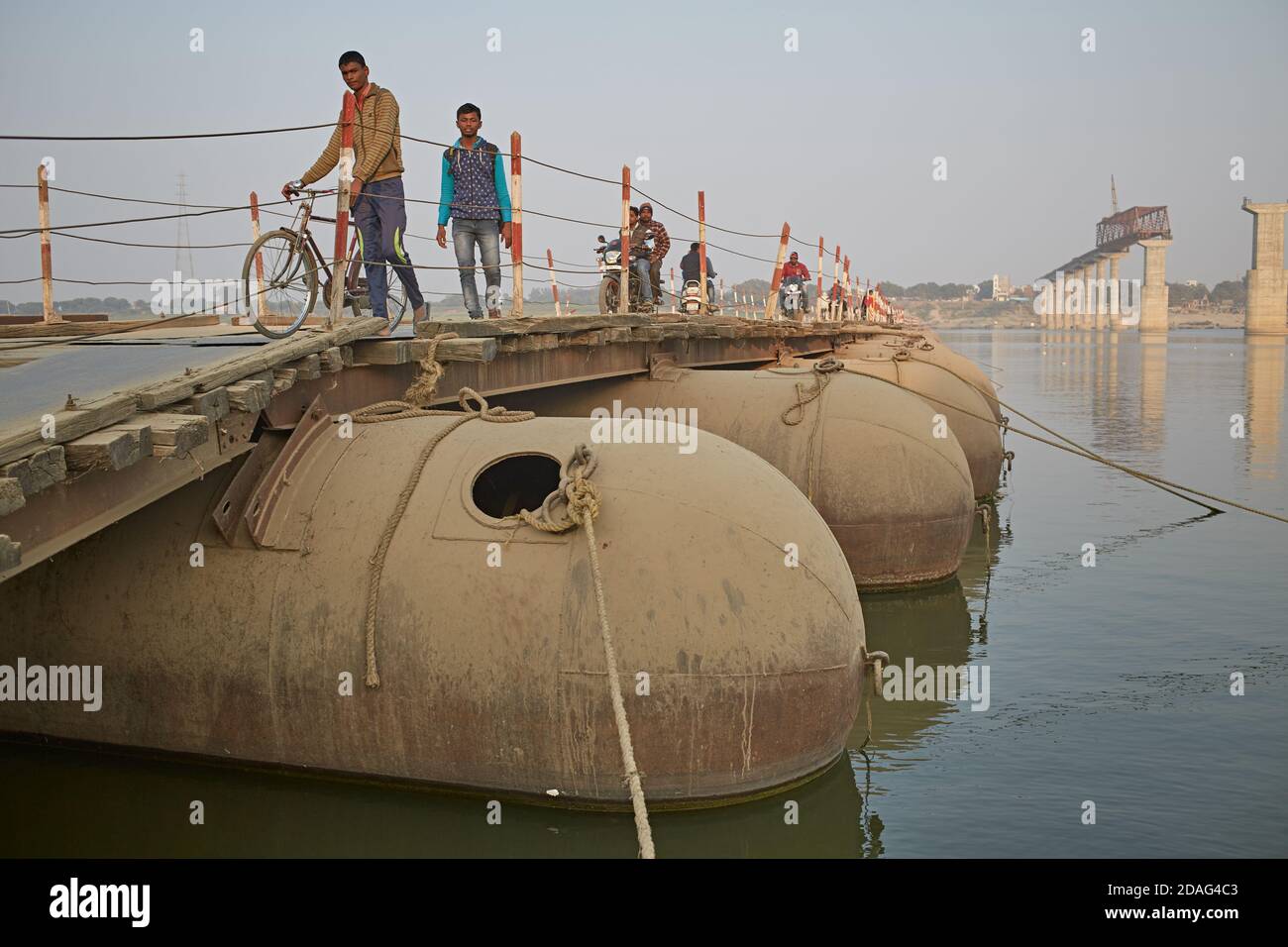 Varanasi, India, December 2015. People crossing a temporary bridge on ...
