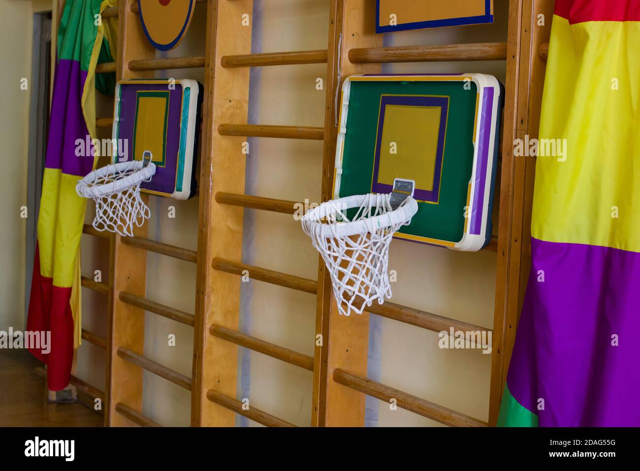 Basketball rings on wall in children's gym Stock Photo - Alamy