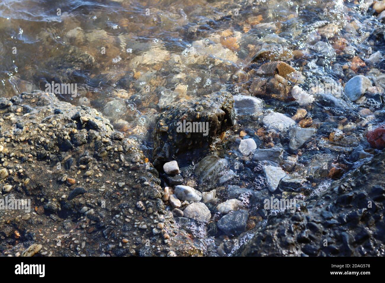 Water brushing onto rocks Stock Photo - Alamy