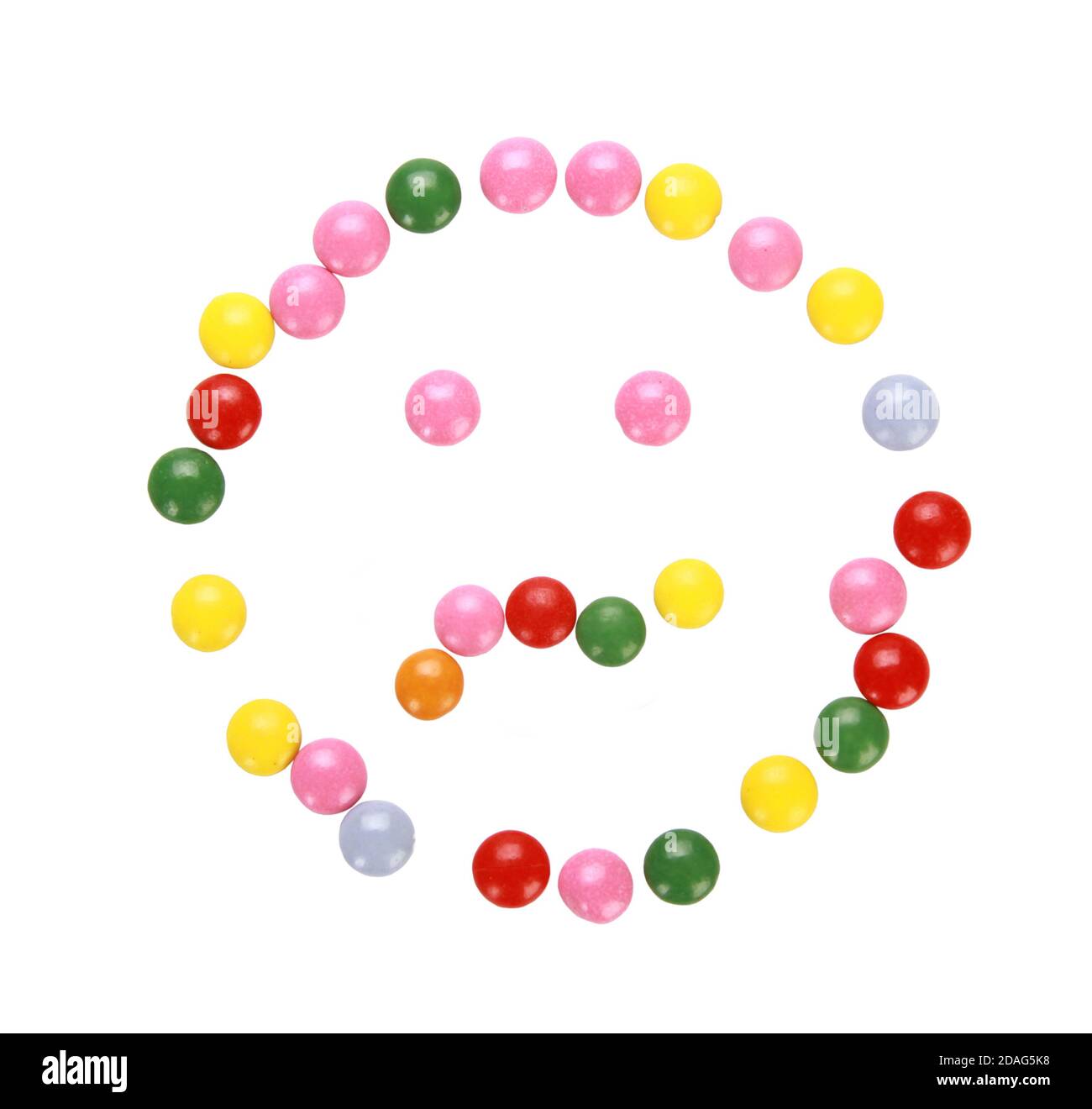 Candies forming a sad face on white background Stock Photo - Alamy