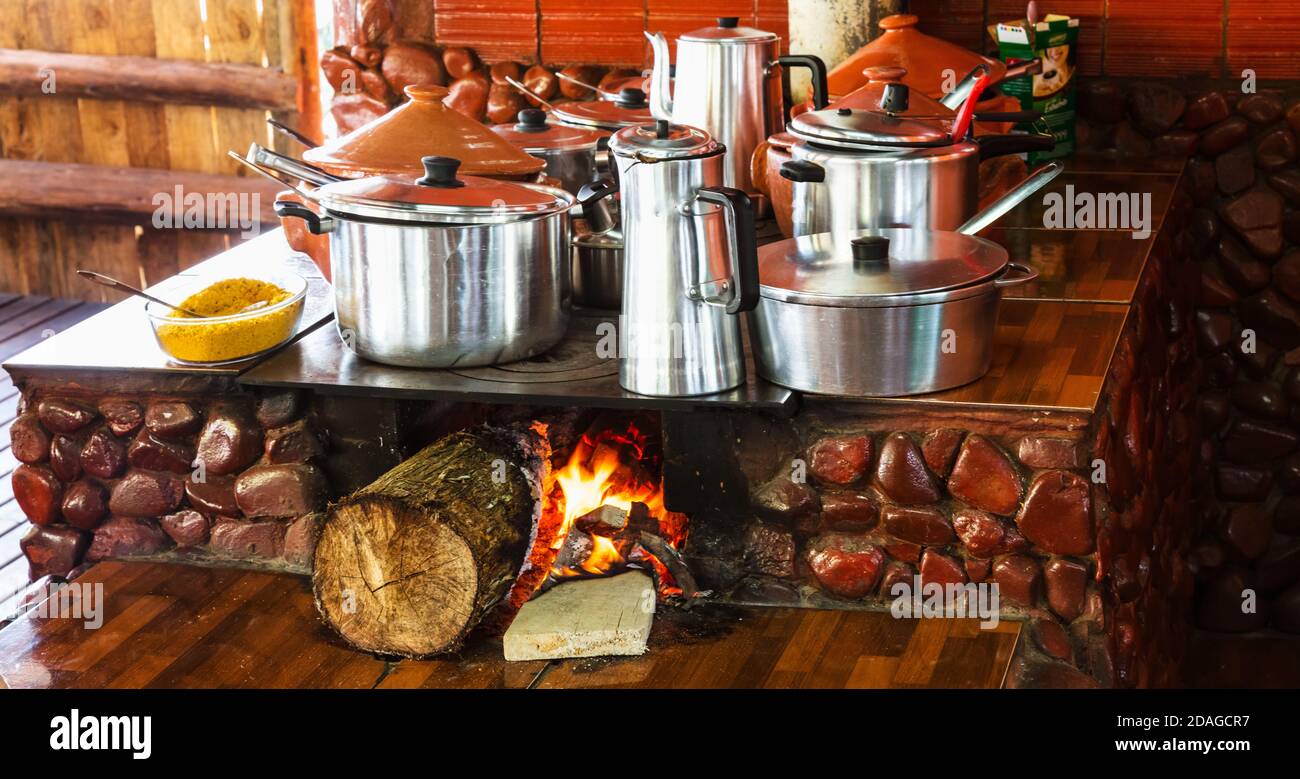 Pots and utensils on a wooden stove Stock Photo - Alamy