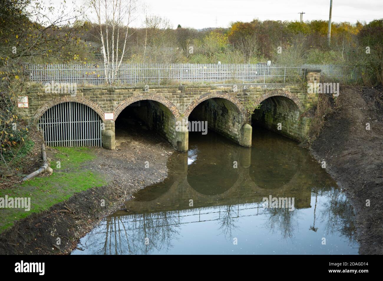 Stone arch railway bridge spanning a river Stock Photo - Alamy