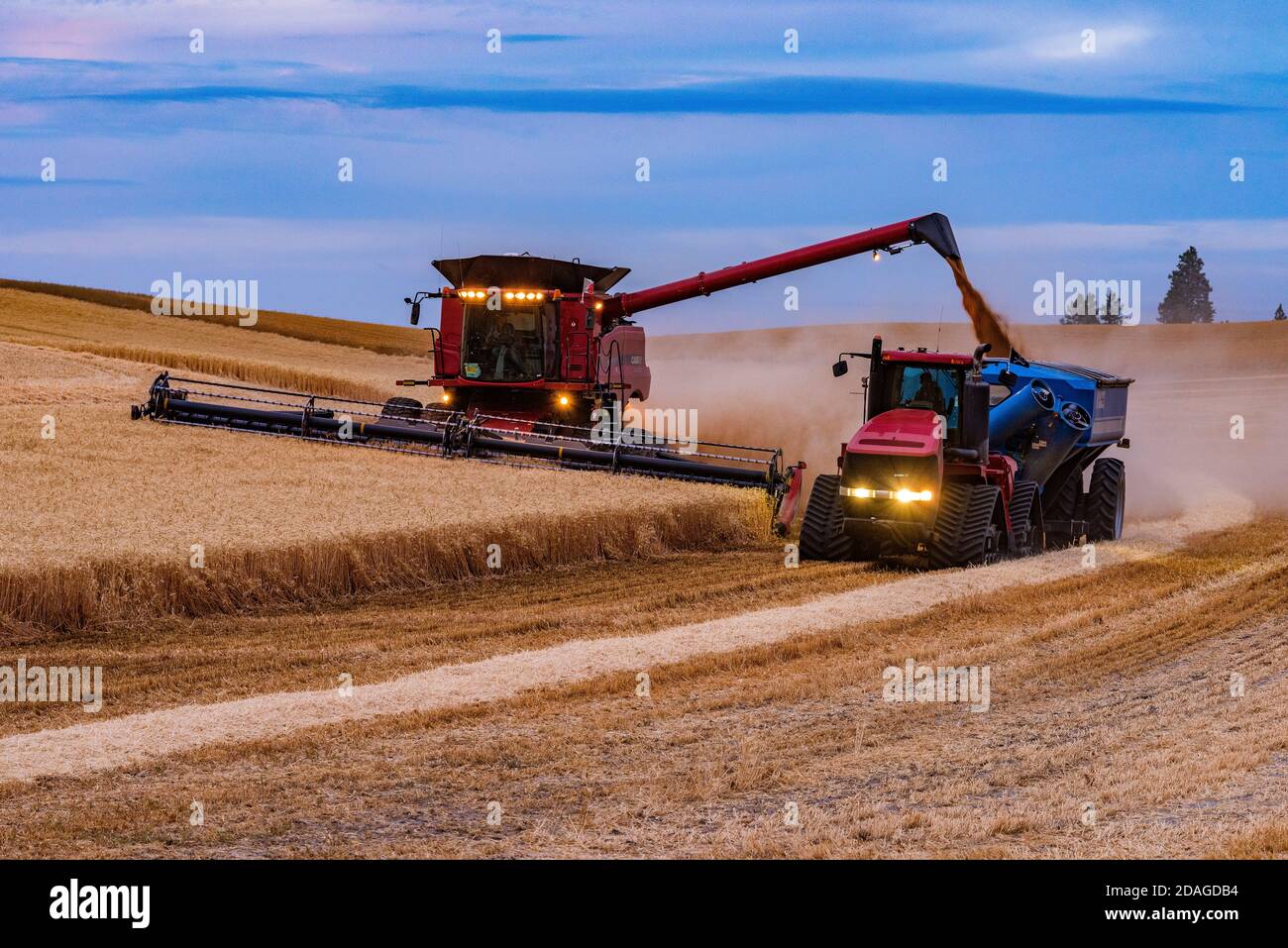 CaseIH combine offloading grain to Kinze grain cart pulled by a ...