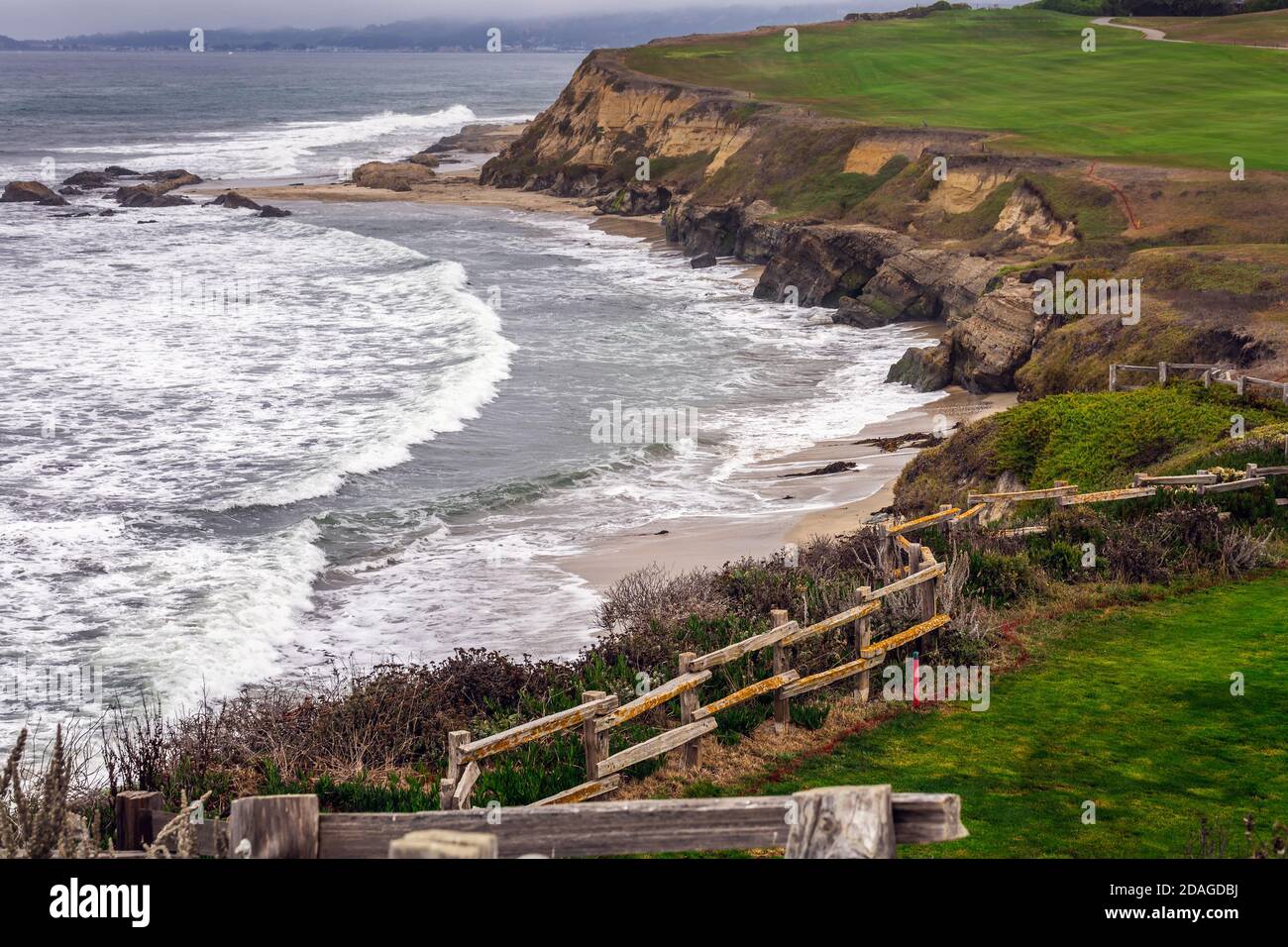 Golf course putting green and cliffs by the pacific ocean bay. Half ...