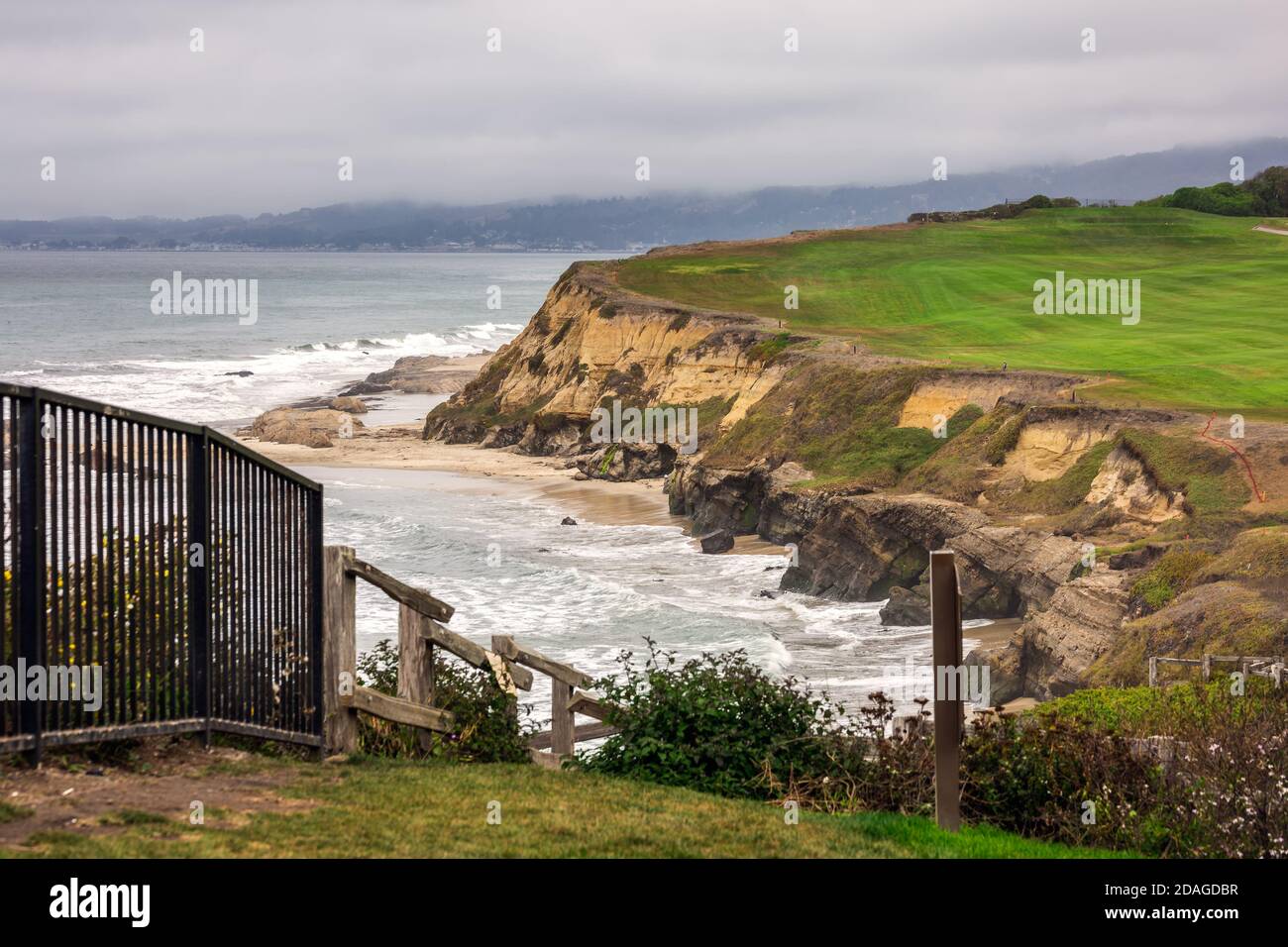 Golf course putting green and cliffs by the pacific ocean bay. Half ...