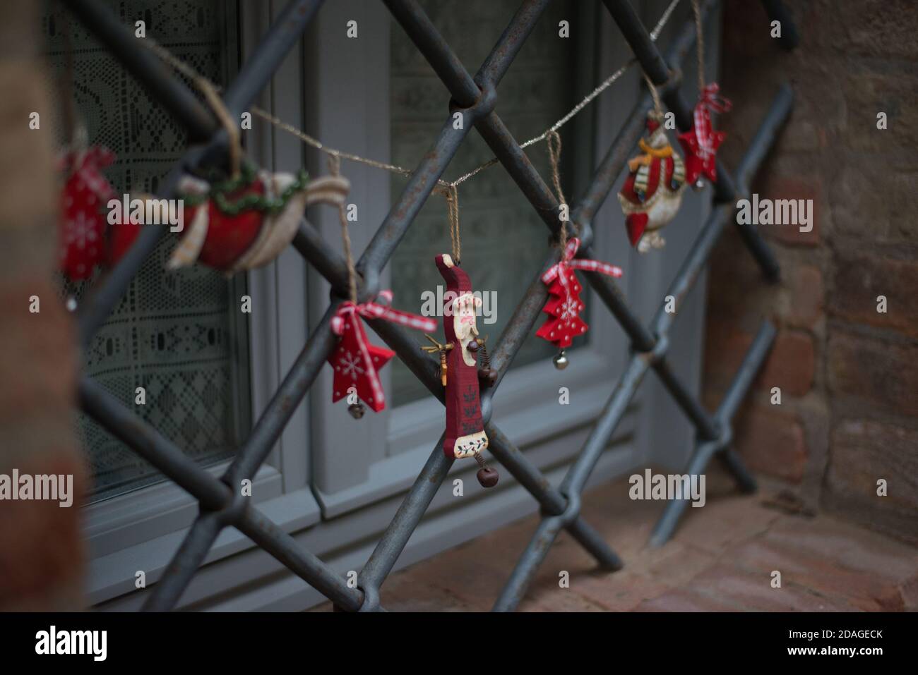 Christmas decorations hanging out of a window railing Stock Photo - Alamy