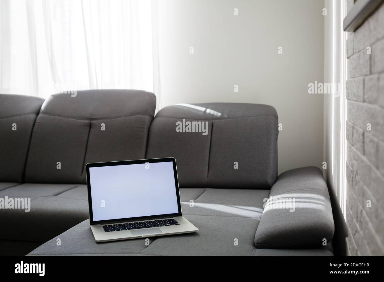 Modern interior. Comfortable workplace. The laptop is on the couch ...