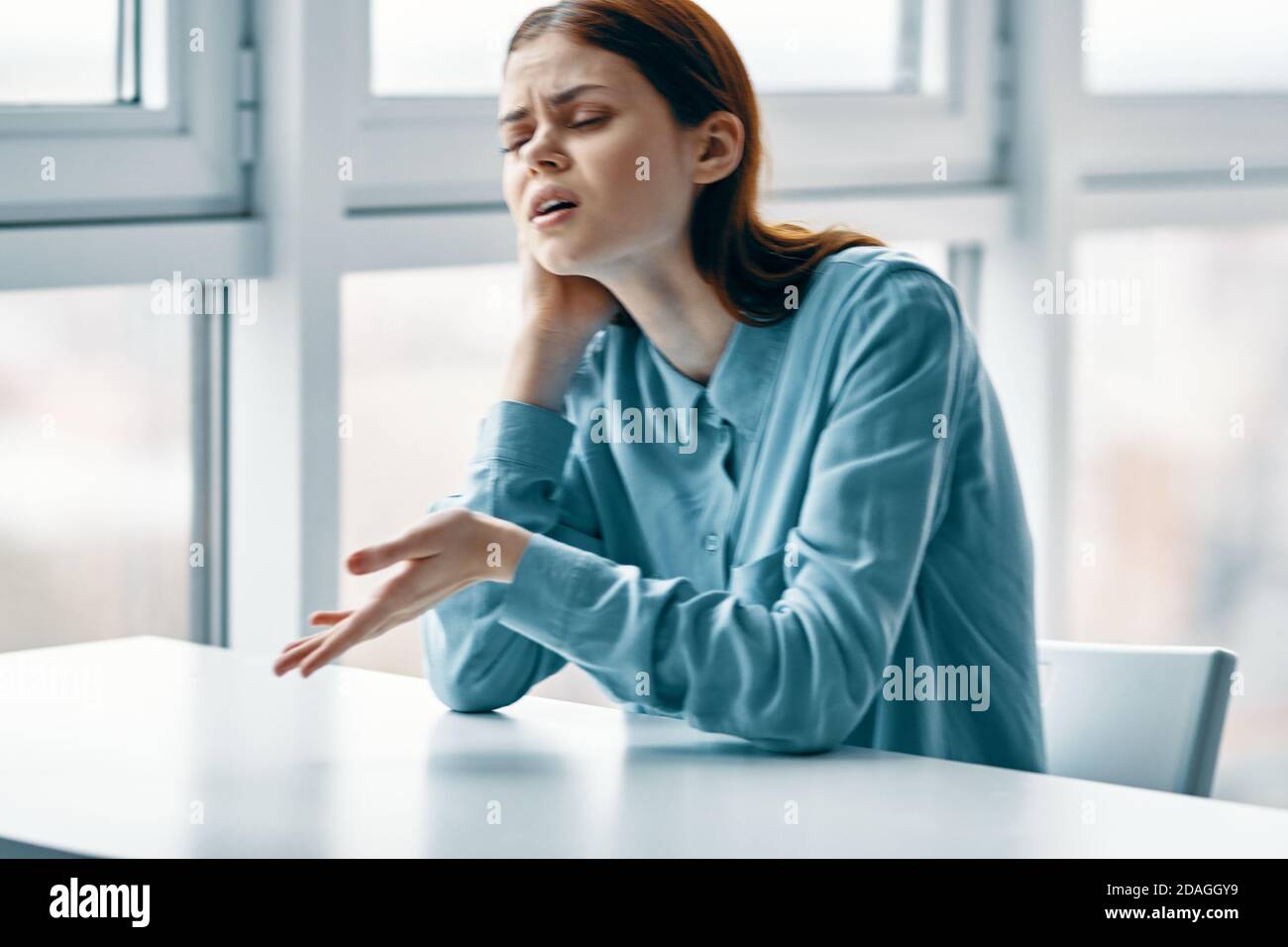 woman works in an office near the window and an indignant face Stock ...
