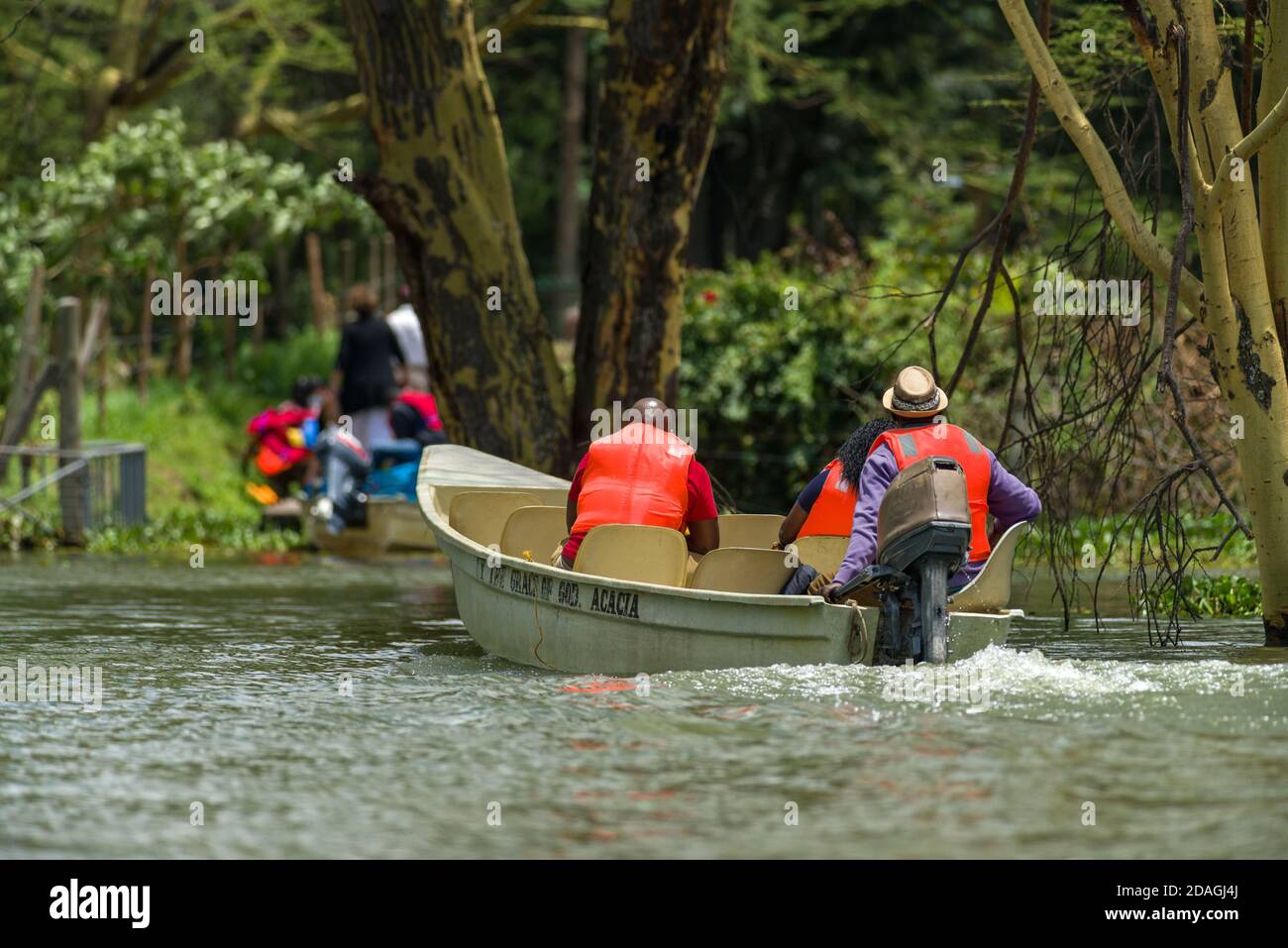Tourists in a small fibreglass boat on a boat safari, Lake Naivasha ...