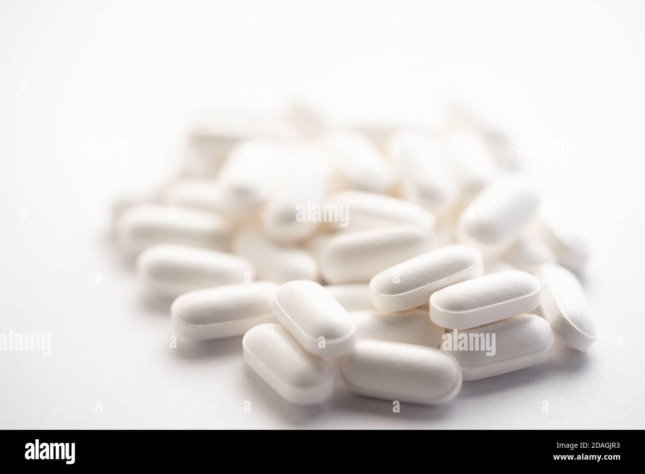 Bunch of little white zinc pills on bright white background Stock Photo ...