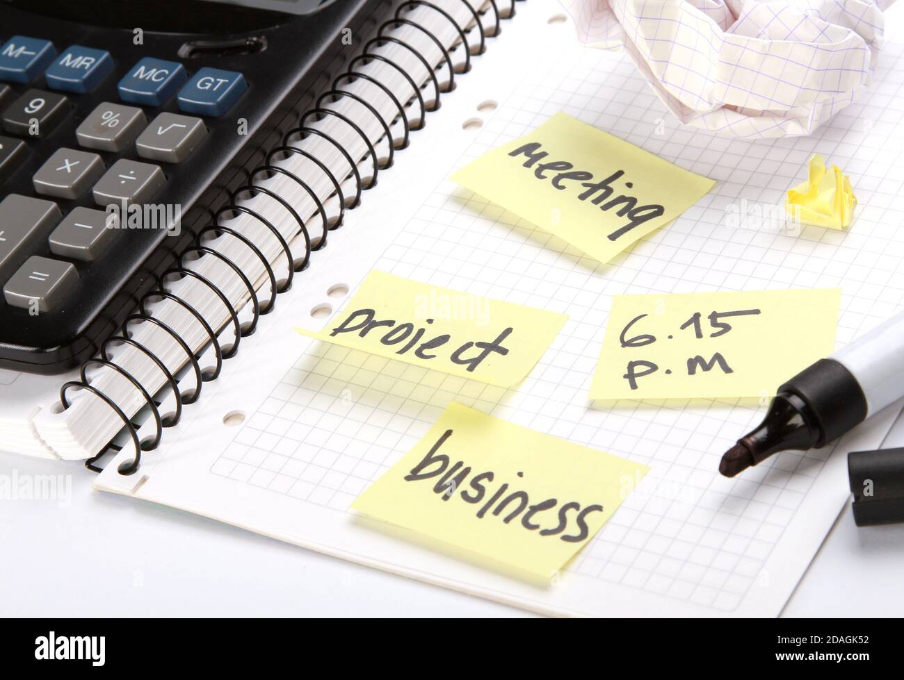 Yellow sticky notes with business word ion a busy desk Stock Photo - Alamy