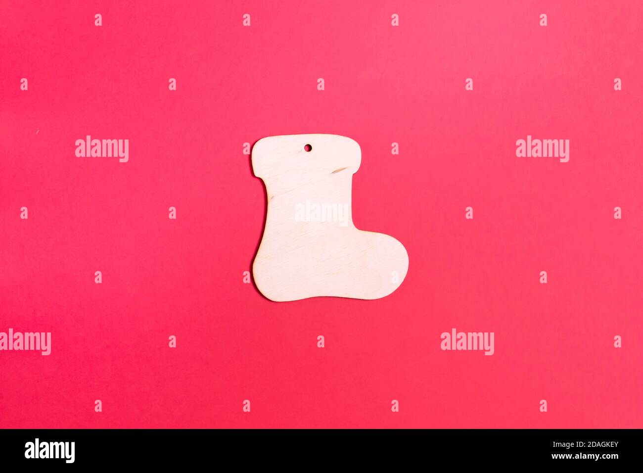 Christmas tree decoration wooden boot on a red background. Natural ...