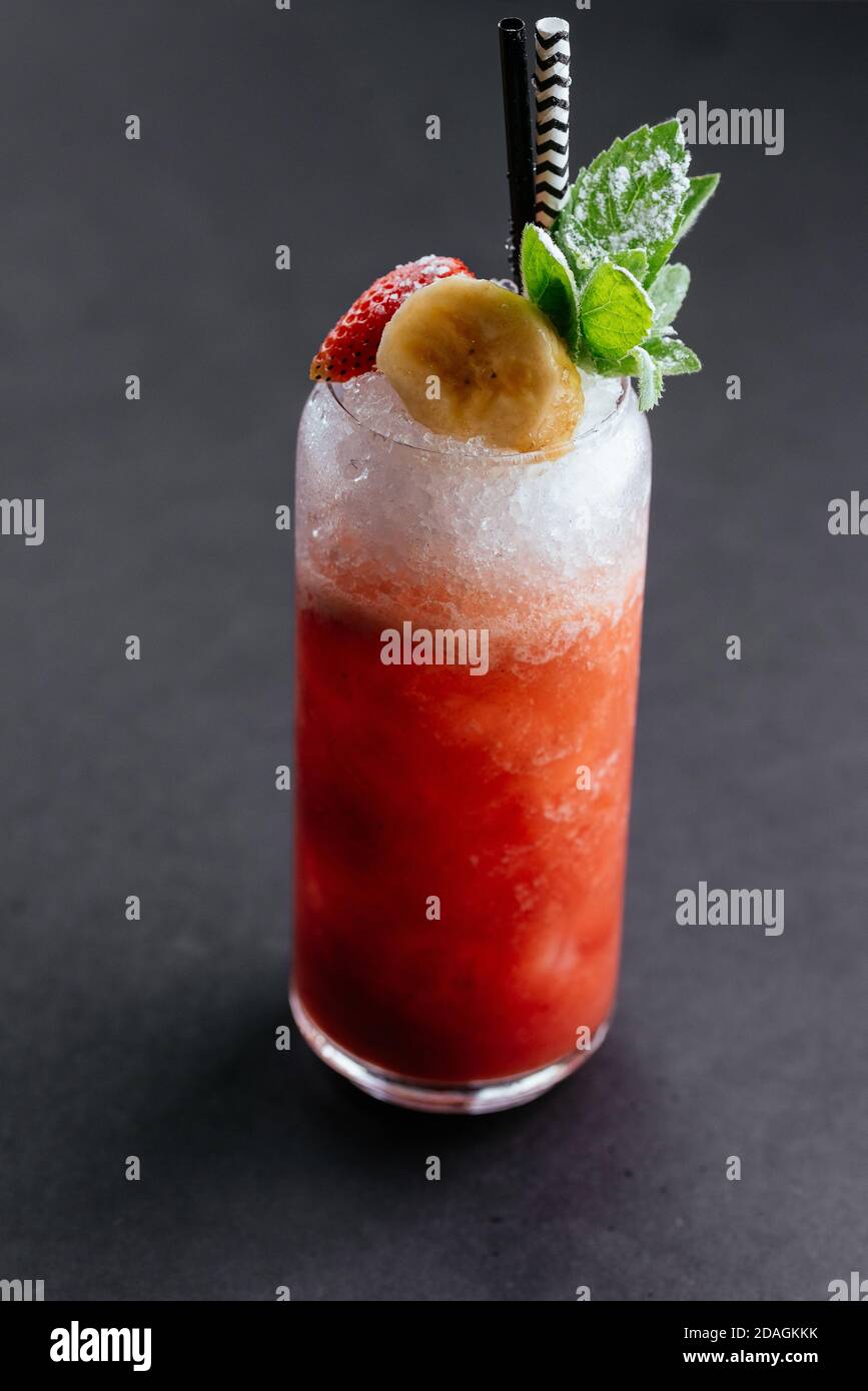 red strawberry alcoholic cocktail on a black background Stock Photo - Alamy