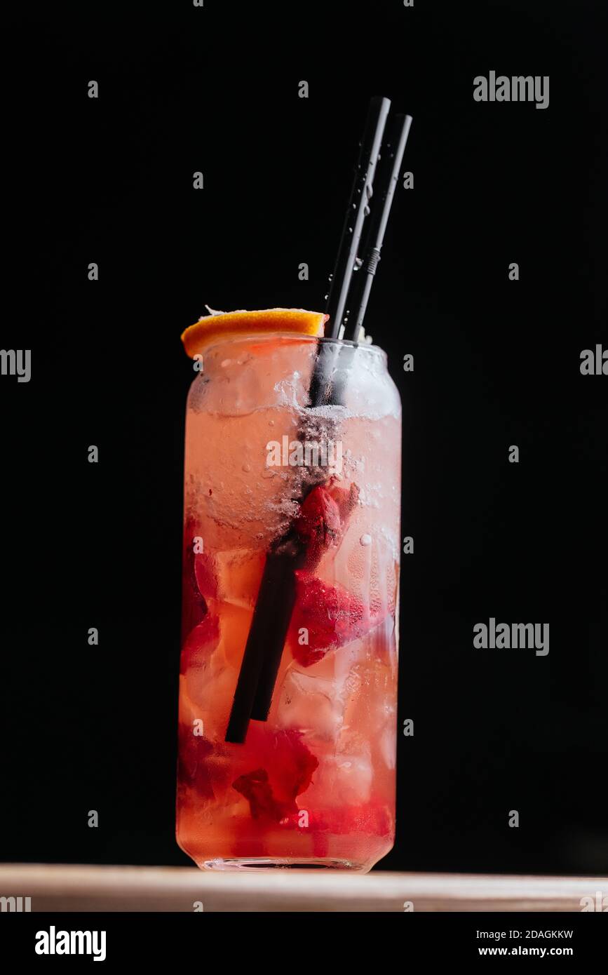 red strawberry alcoholic cocktail on a black background Stock Photo - Alamy