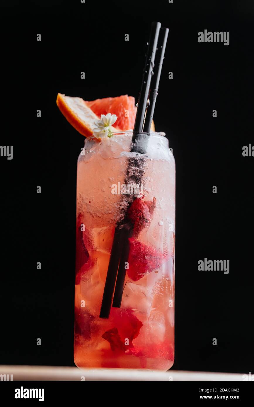 red strawberry alcoholic cocktail on a black background Stock Photo - Alamy
