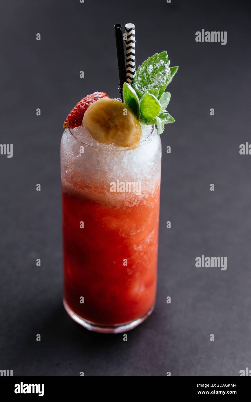red strawberry alcoholic cocktail on a black background Stock Photo - Alamy