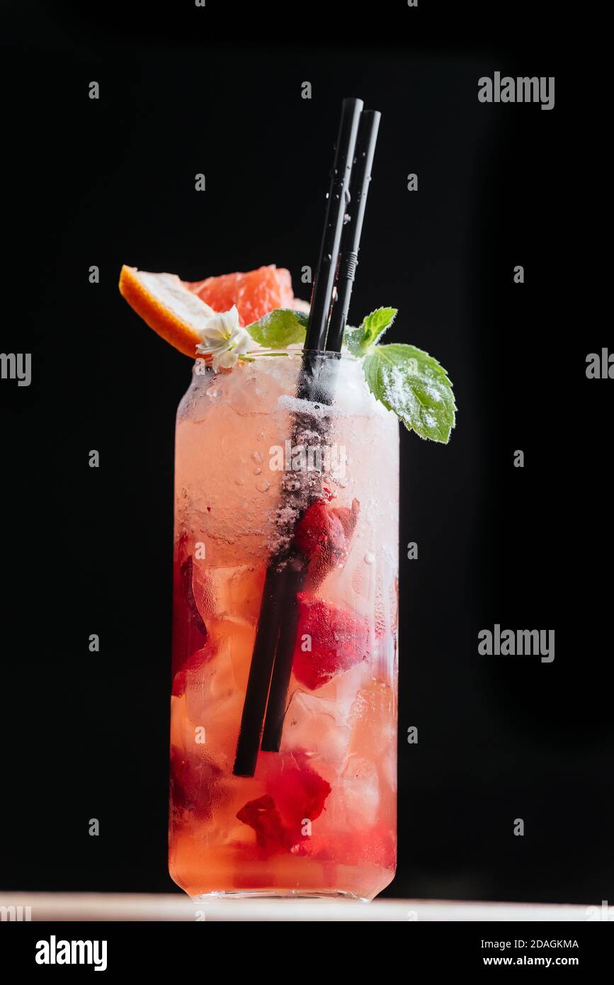 red strawberry alcoholic cocktail on a black background Stock Photo - Alamy
