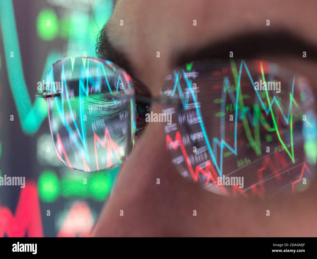 Stock market data on computer screen being reflected onto glasses Stock ...