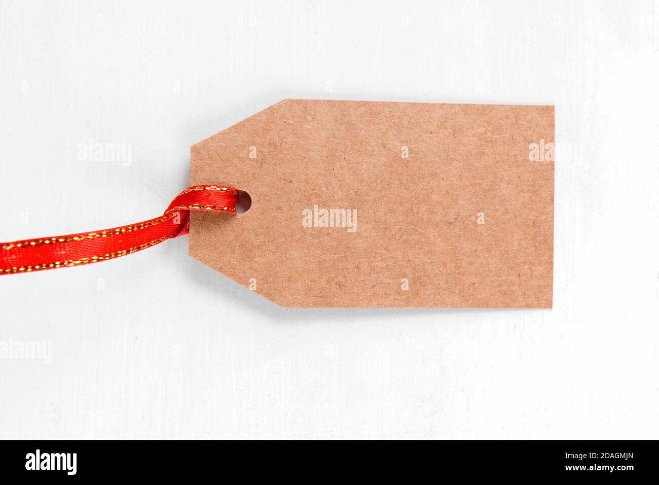 Christmas gift tag mock up of craft paper present label with red ribbon ...